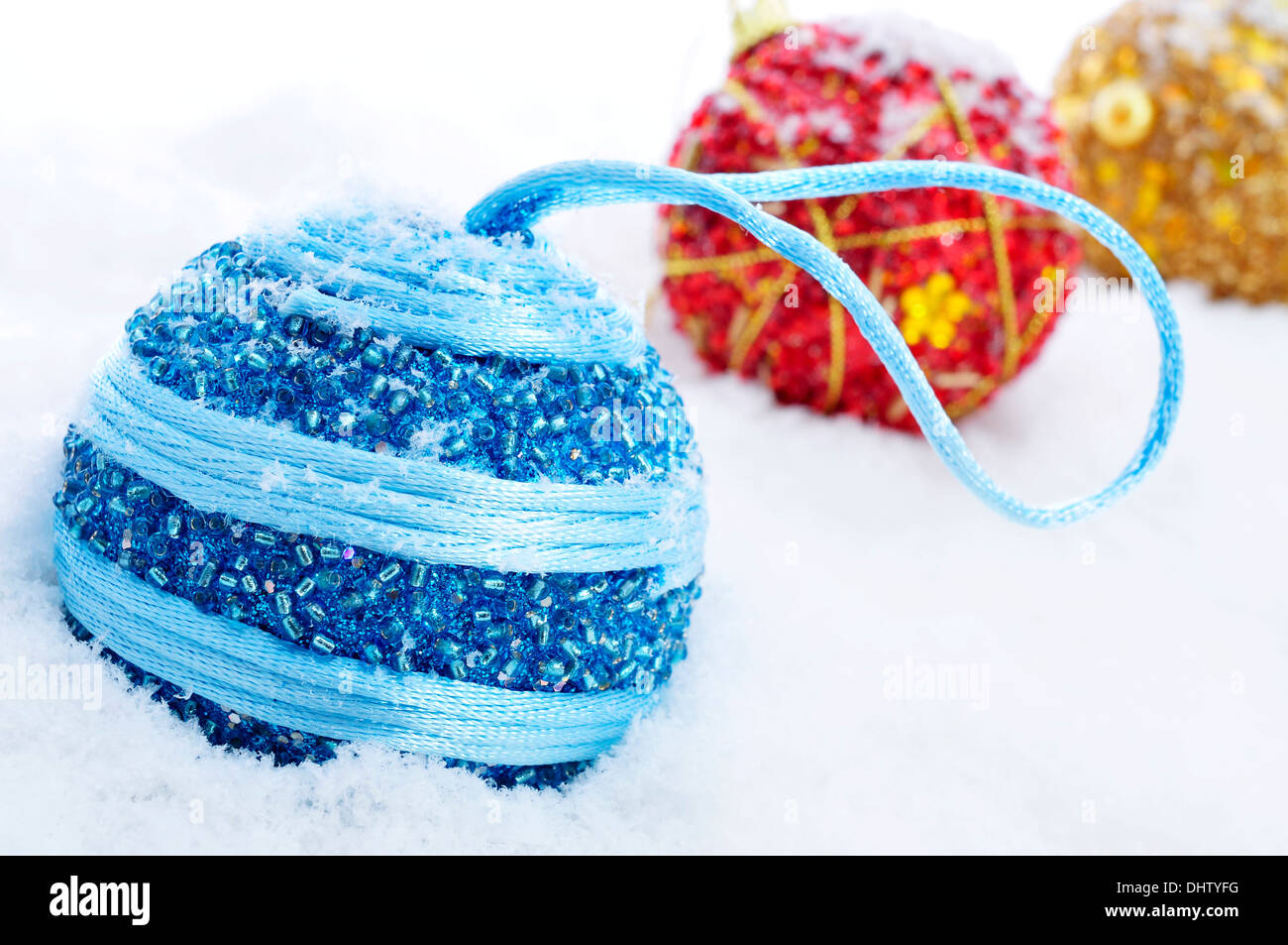 some christmas balls of different colors on the snow Stock Photo - Alamy