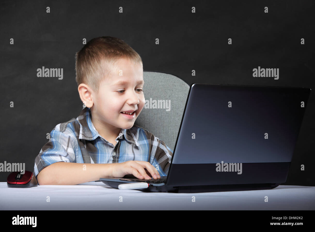 Computer addiction child boy with laptop notebook black background ...