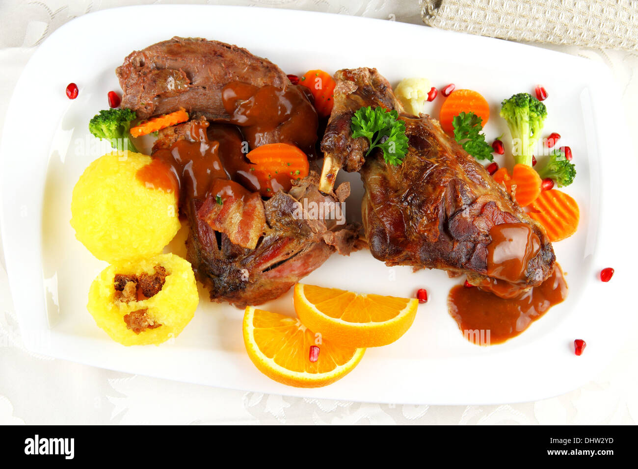 Braised rabbit meat with potato dumplings and vegetables, top view ...