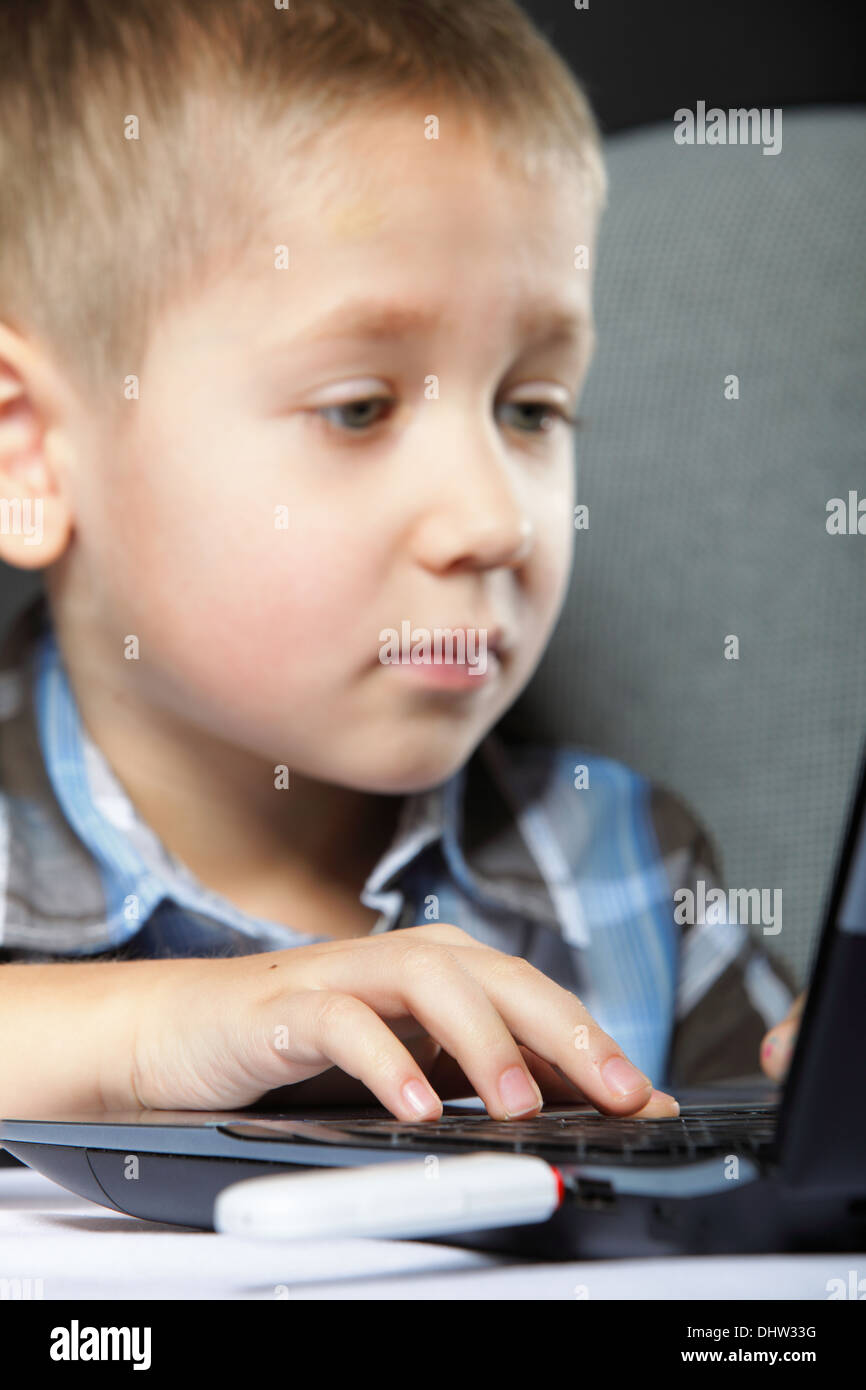 Computer addiction child boy with laptop notebook black background ...