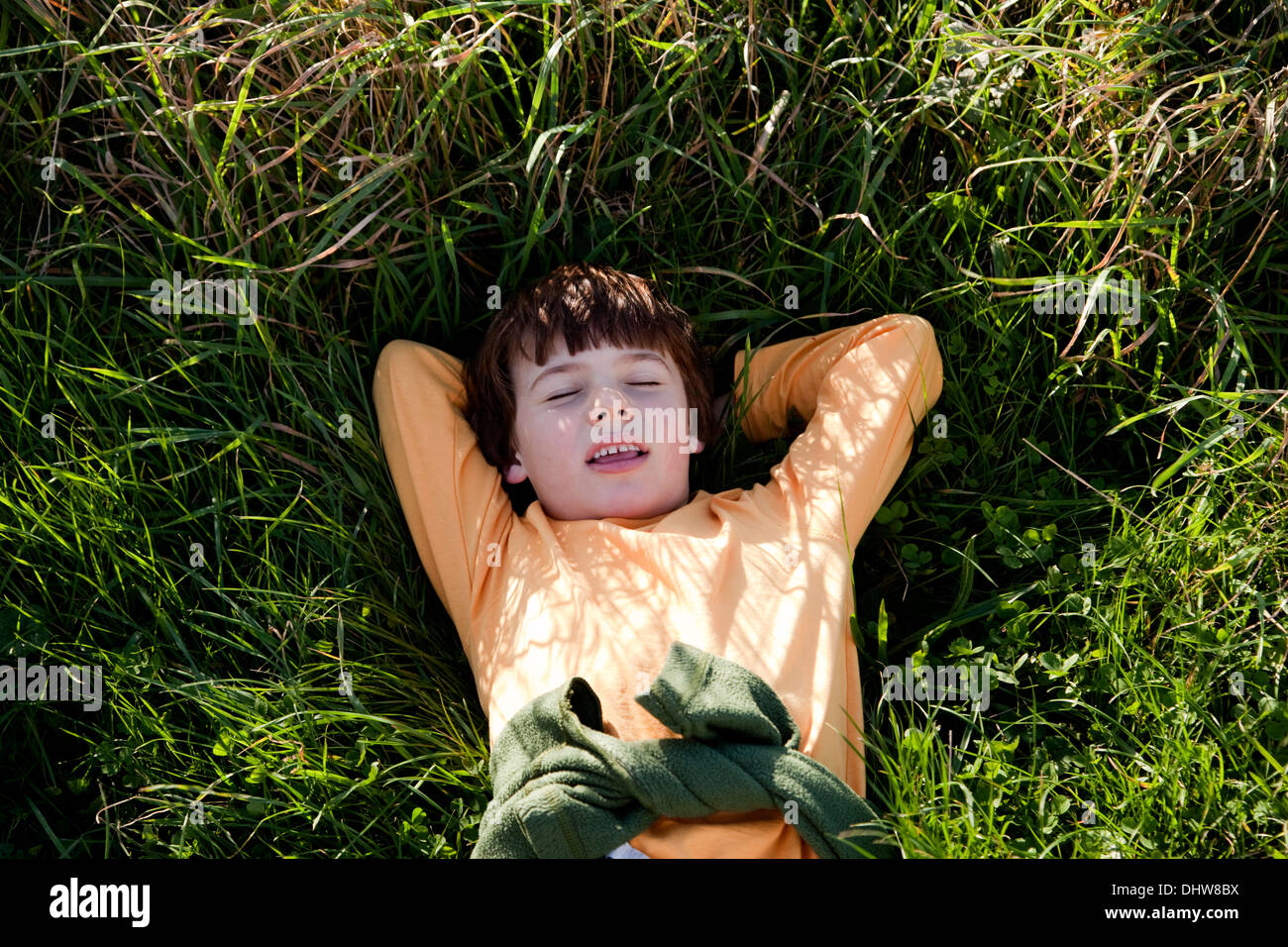 boy sleeping in grass Stock Photo - Alamy