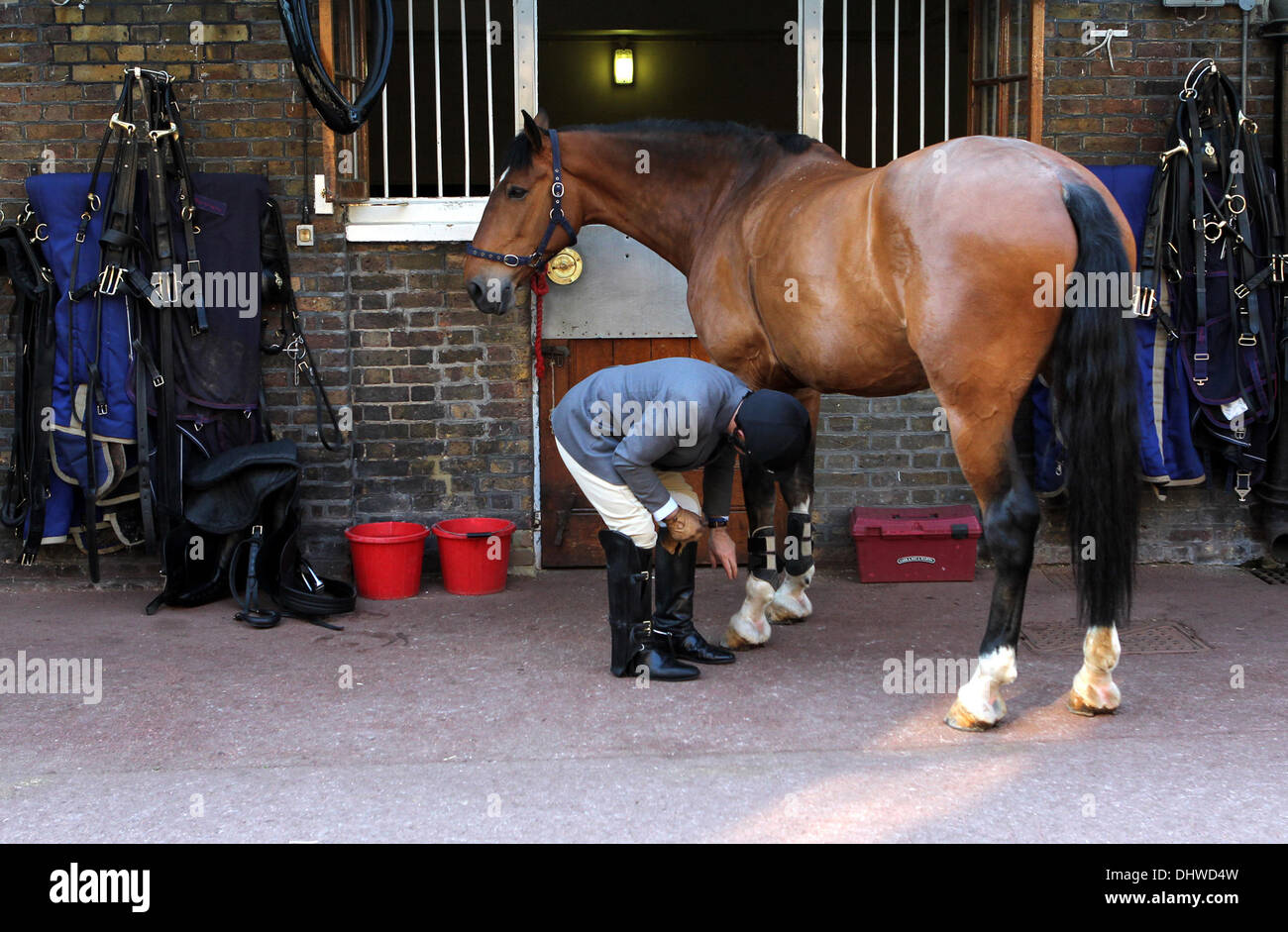 Coachmen prepare the horses at the Royal Mews in Buckingham Palace, as ...