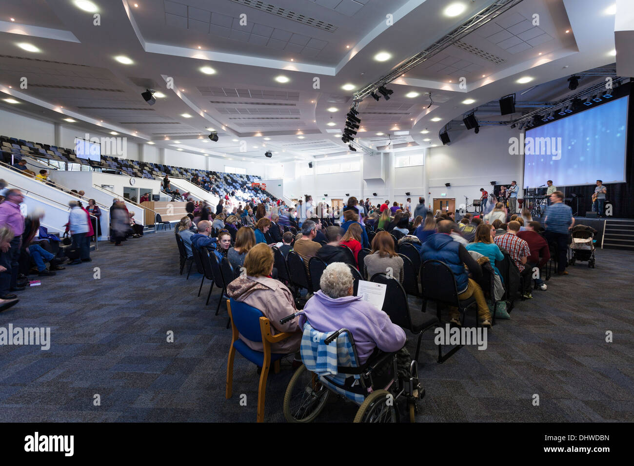 Congregation participating in contemporary worship music during Sunday ...