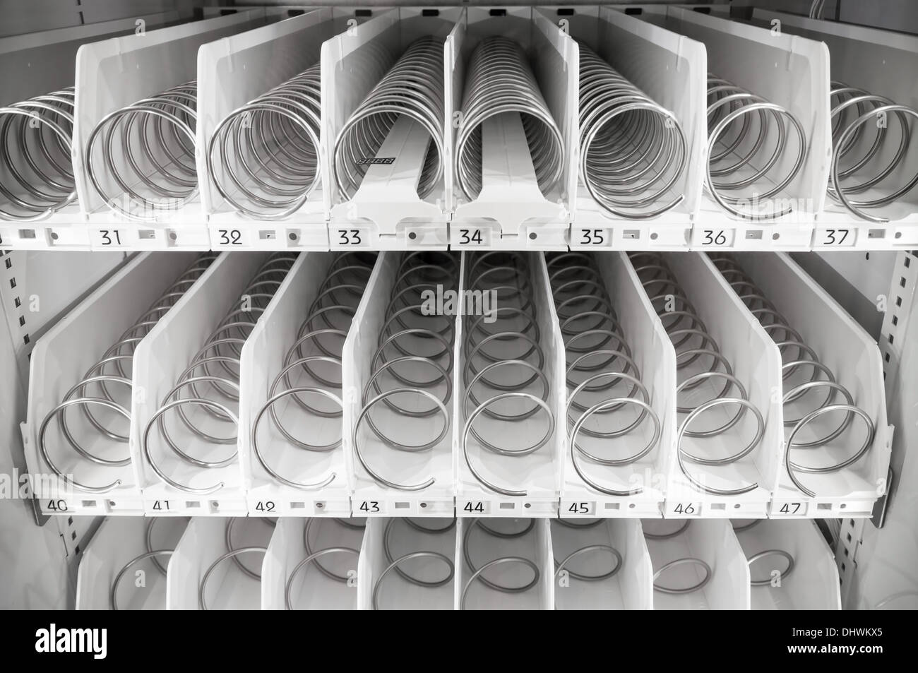 Empty white shelves of standard office vending machine Stock Photo - Alamy