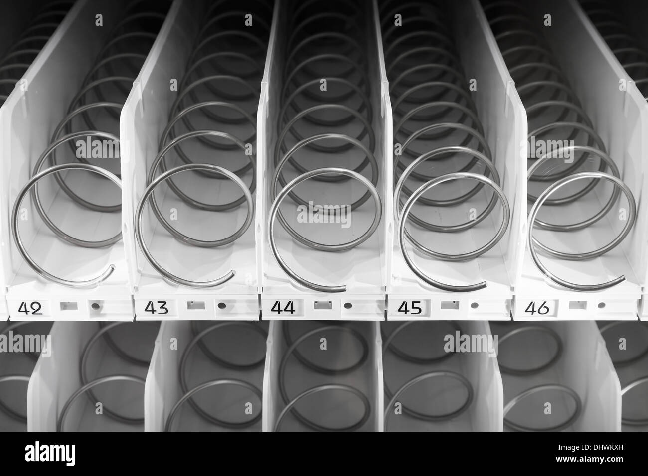 Empty white shelf of standard office vending machine Stock Photo - Alamy