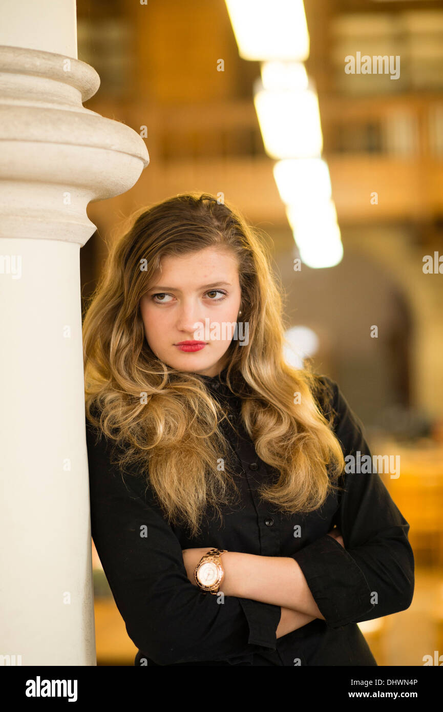 A young sad lonely pensive thoughtful moody single blonde woman teenage ...