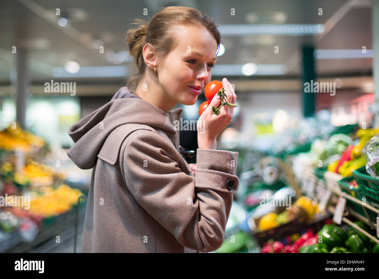 Beautiful young woman shopping for fruits and vegetables in produce ...