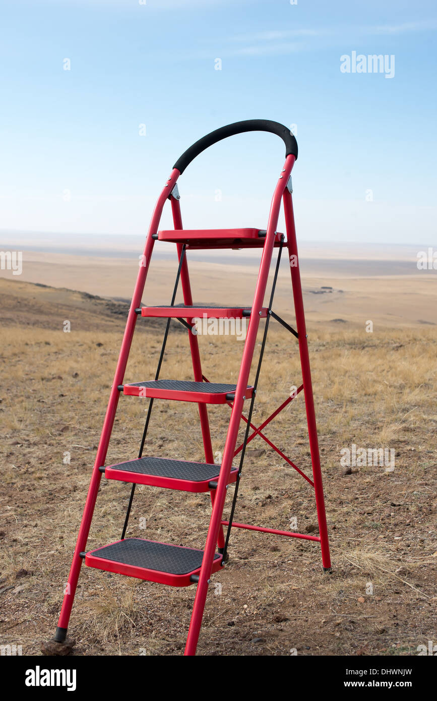 A red ladder in the outdoor lawn Stock Photo - Alamy