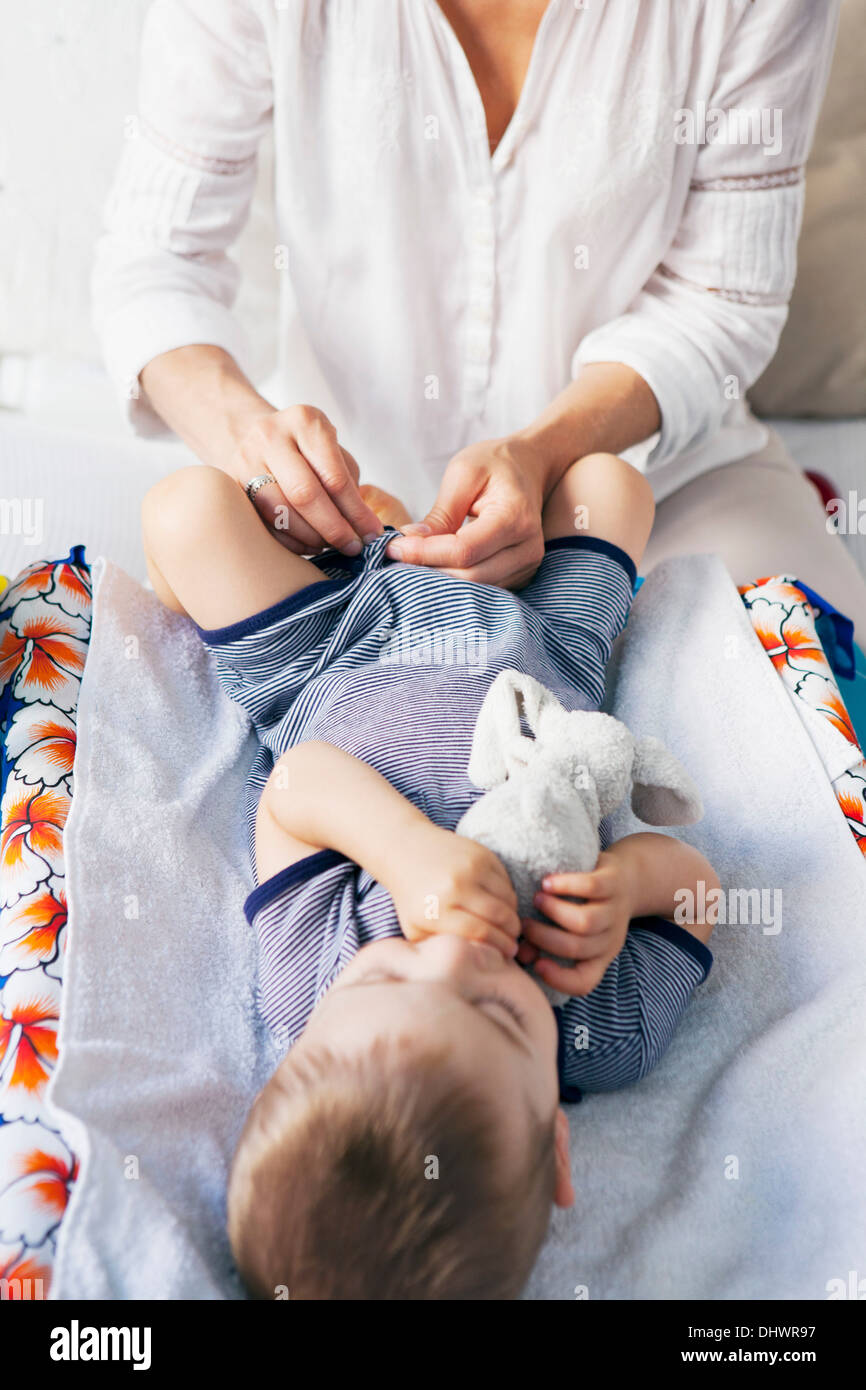 Woman dressing child hi-res stock photography and images - Alamy