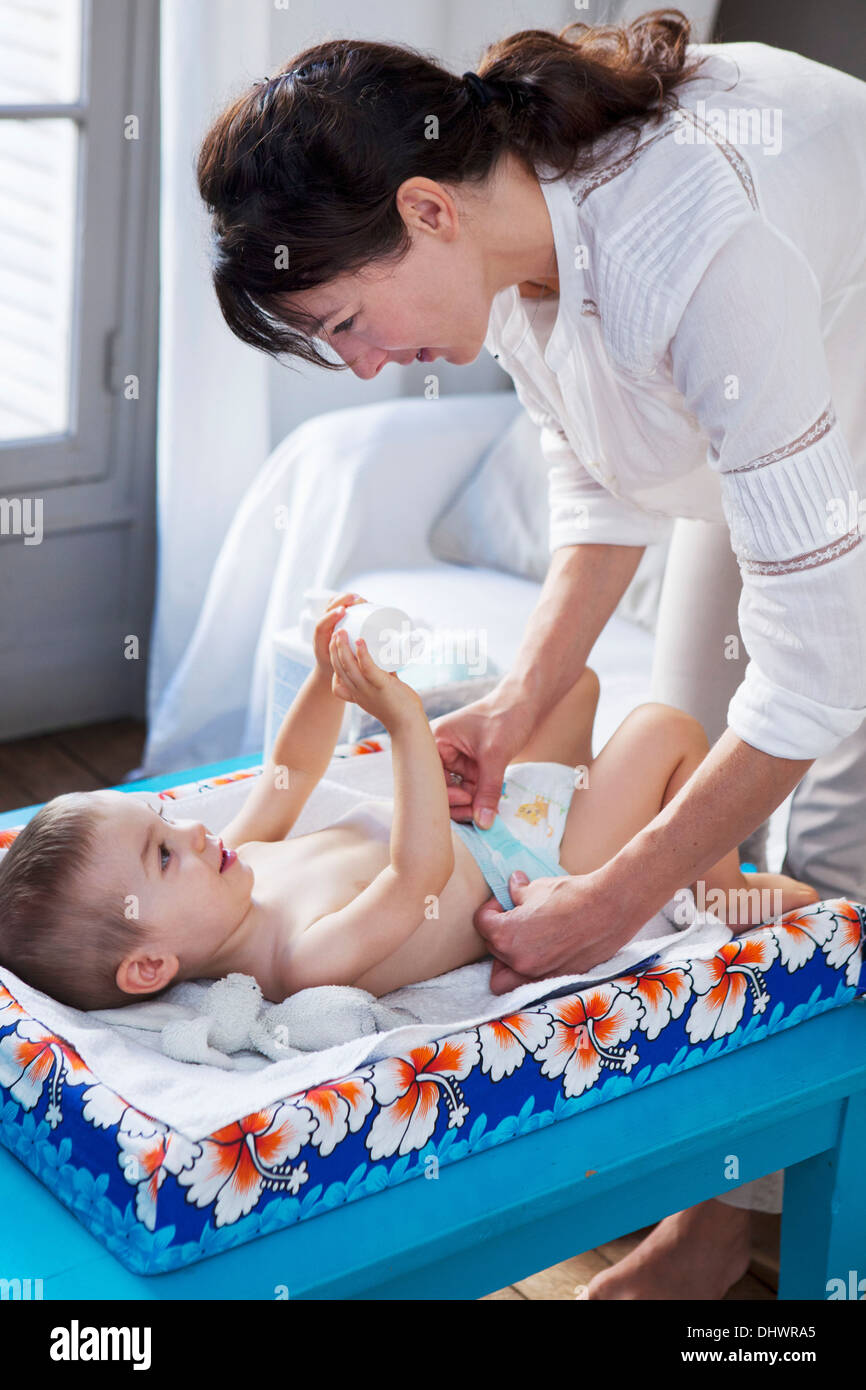 Woman changing sons diaper hi-res stock photography and images - Alamy