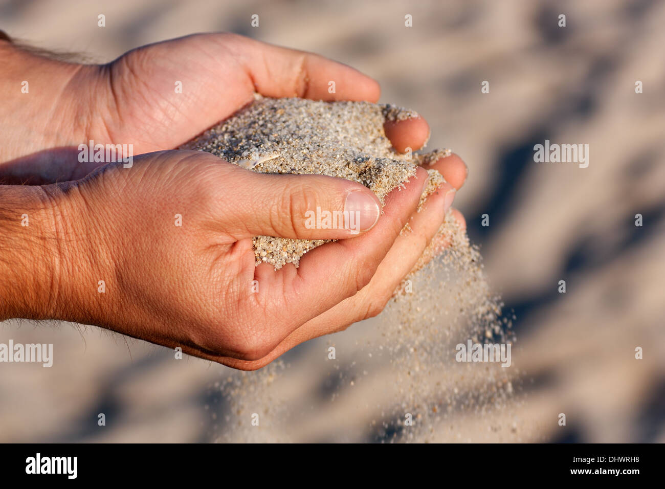Man hands holding spilling sand hi-res stock photography and images - Alamy