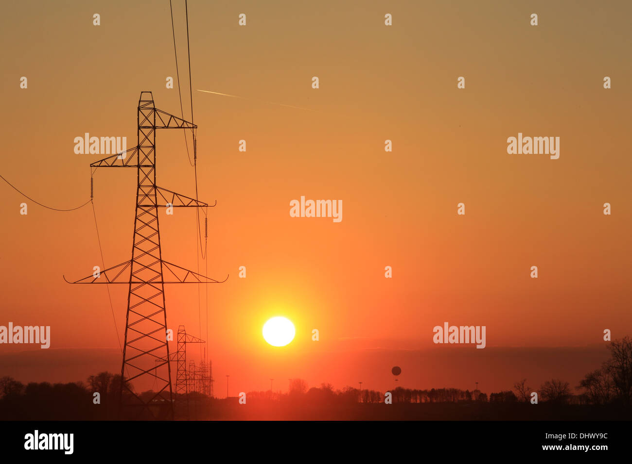 Electricity pylons sunset Stock Photo - Alamy
