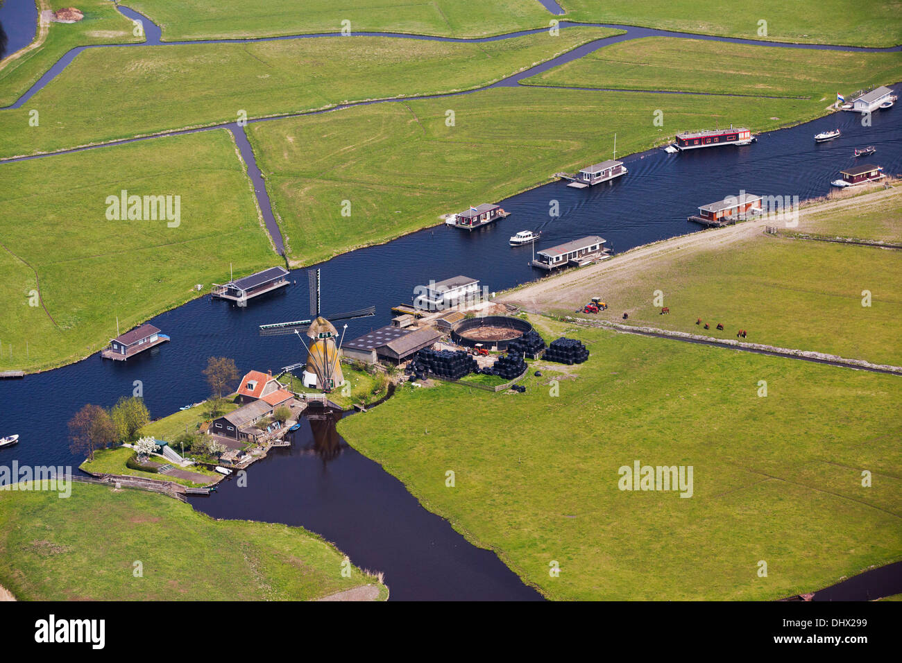 Netherlands, Warmond, houseboats and windmill in lakes called Kager ...