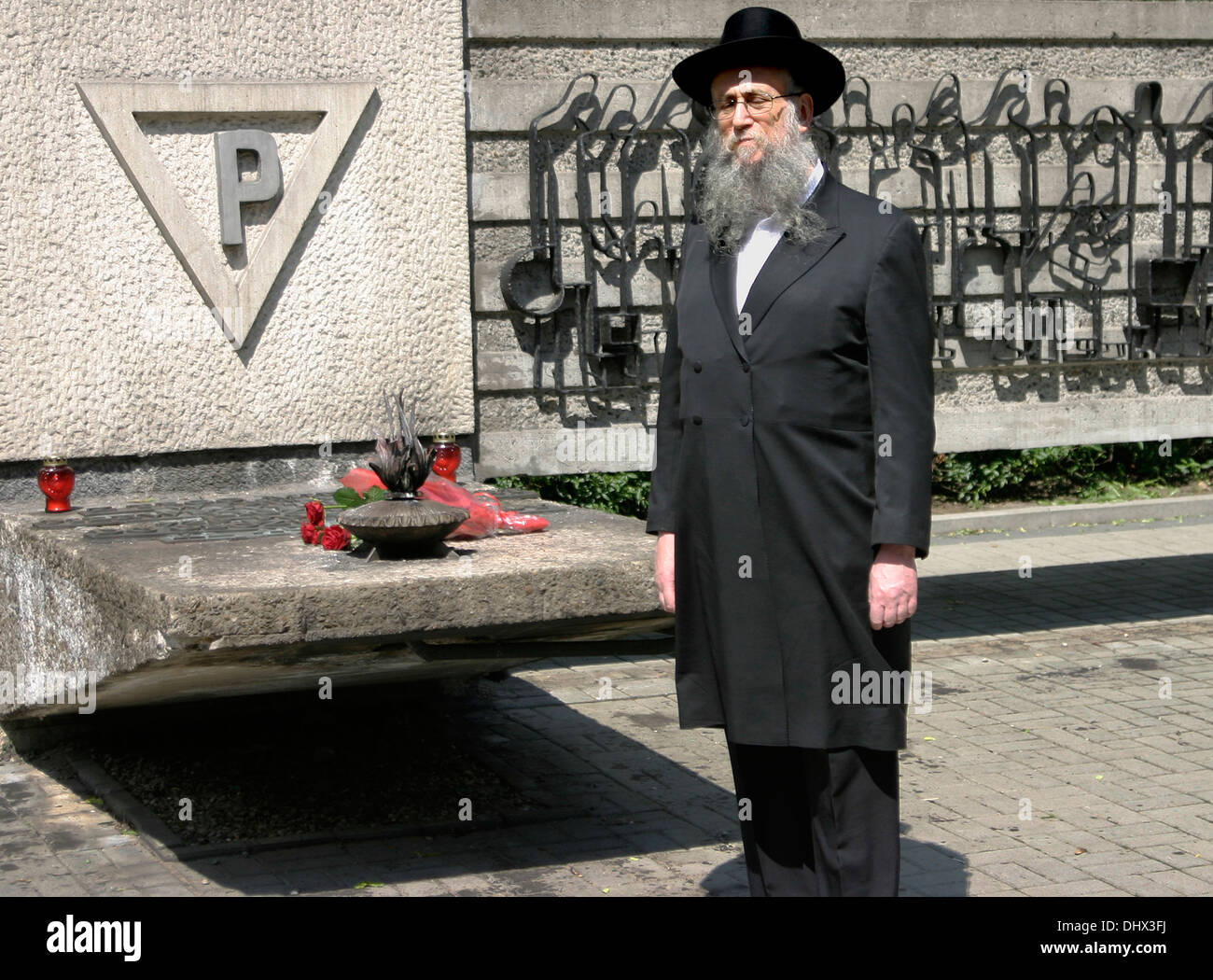 Jewish man standing in front of Tarnow Jewish Ghetto monument to the ...