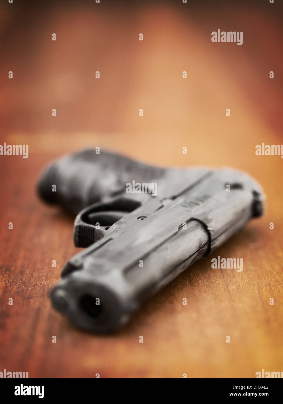 A pistol laying on a wooden floor Stock Photo - Alamy