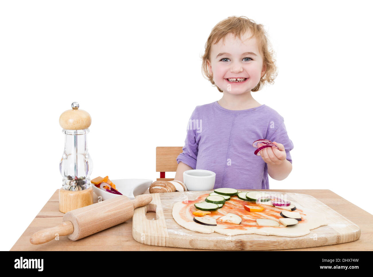 cute child making fresh pizza . studio shot isolated on white ...