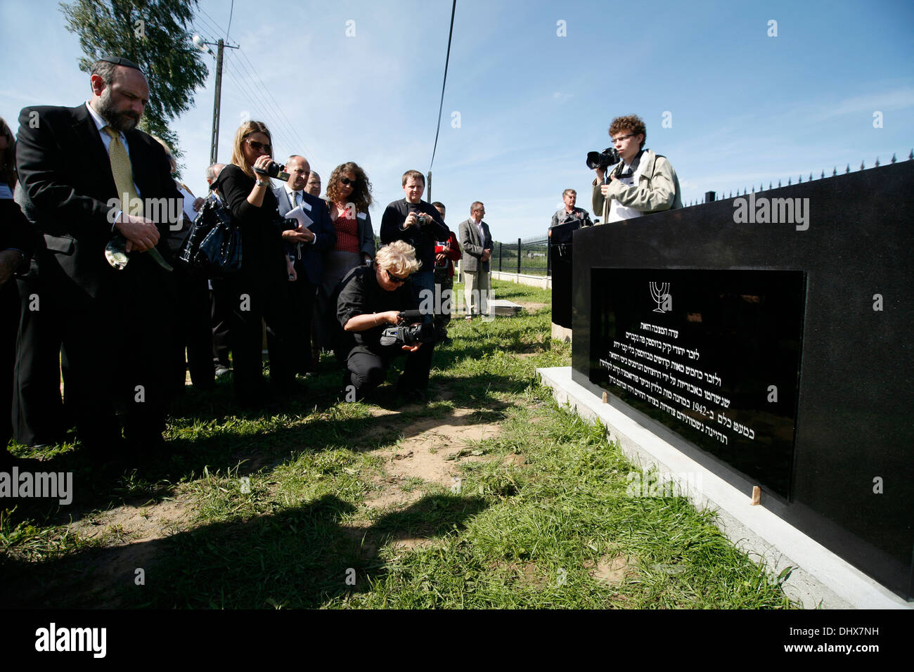 Polish Chief Rabbi Michael Schudrich standing by the memorial stone at ...