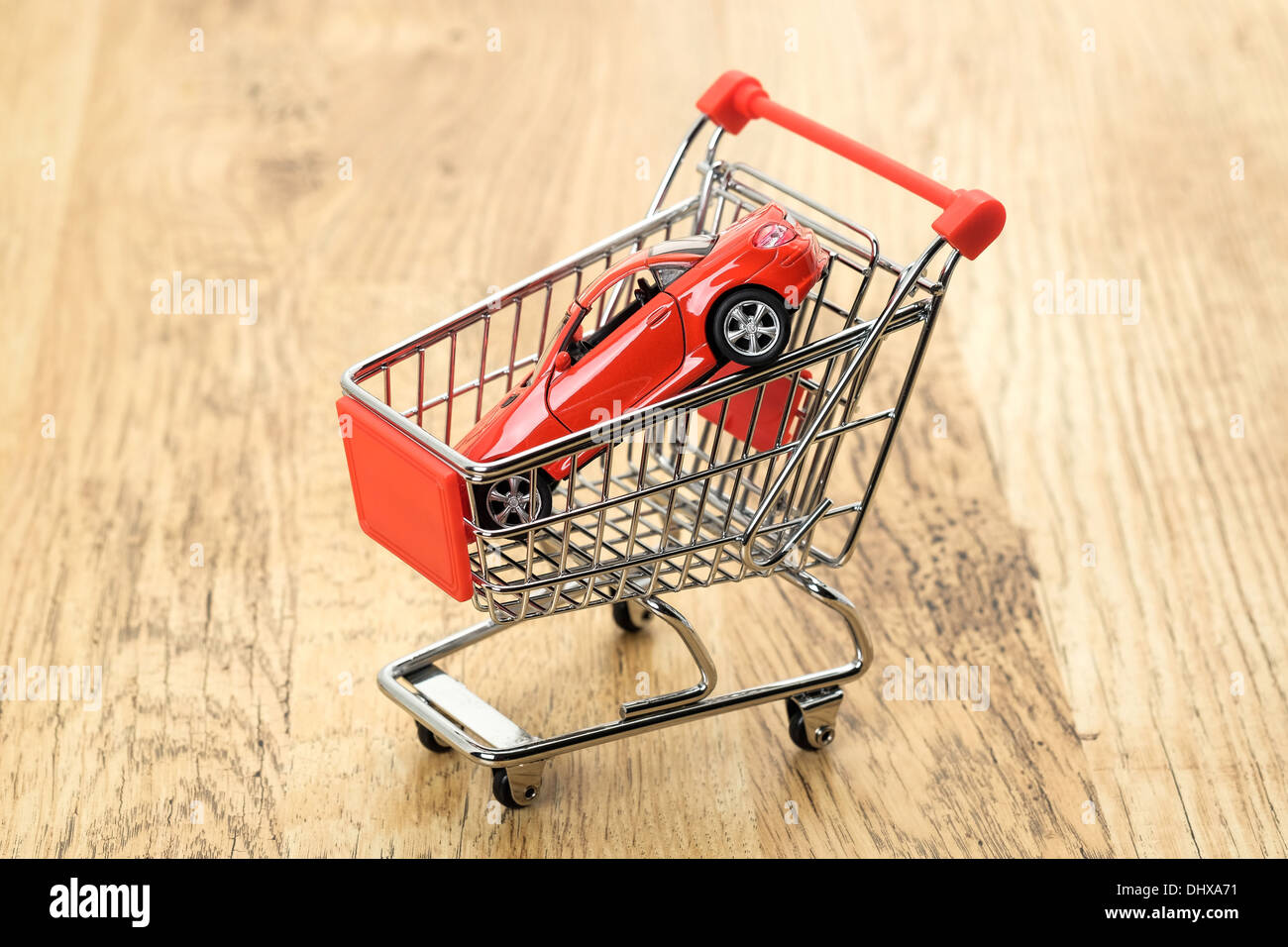 A conceptual image of an expensive sports car in a supermarket shopping ...