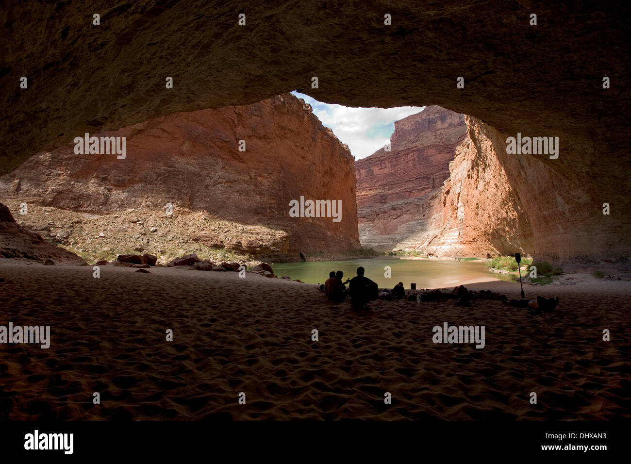A group of rafters relaxes and plays guitars inside the Redwall Cavern ...