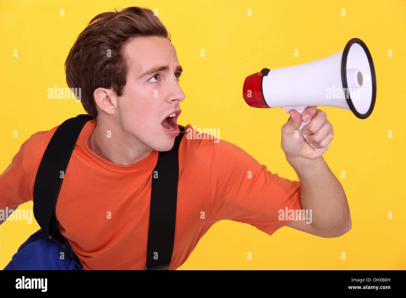 Man shouting into megaphone Stock Photo - Alamy