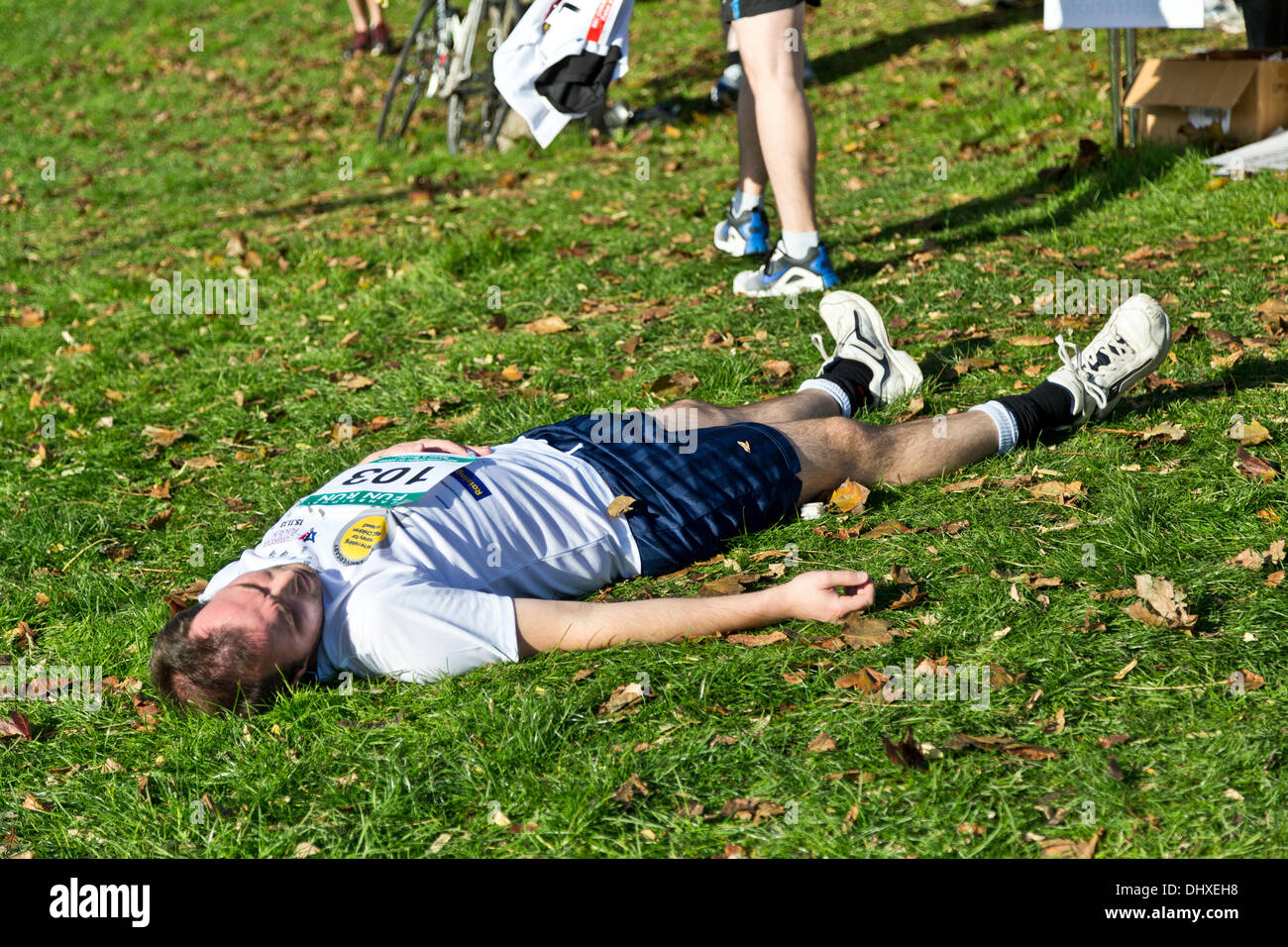 A runner lying on the ground taking a much needed rest after completing ...