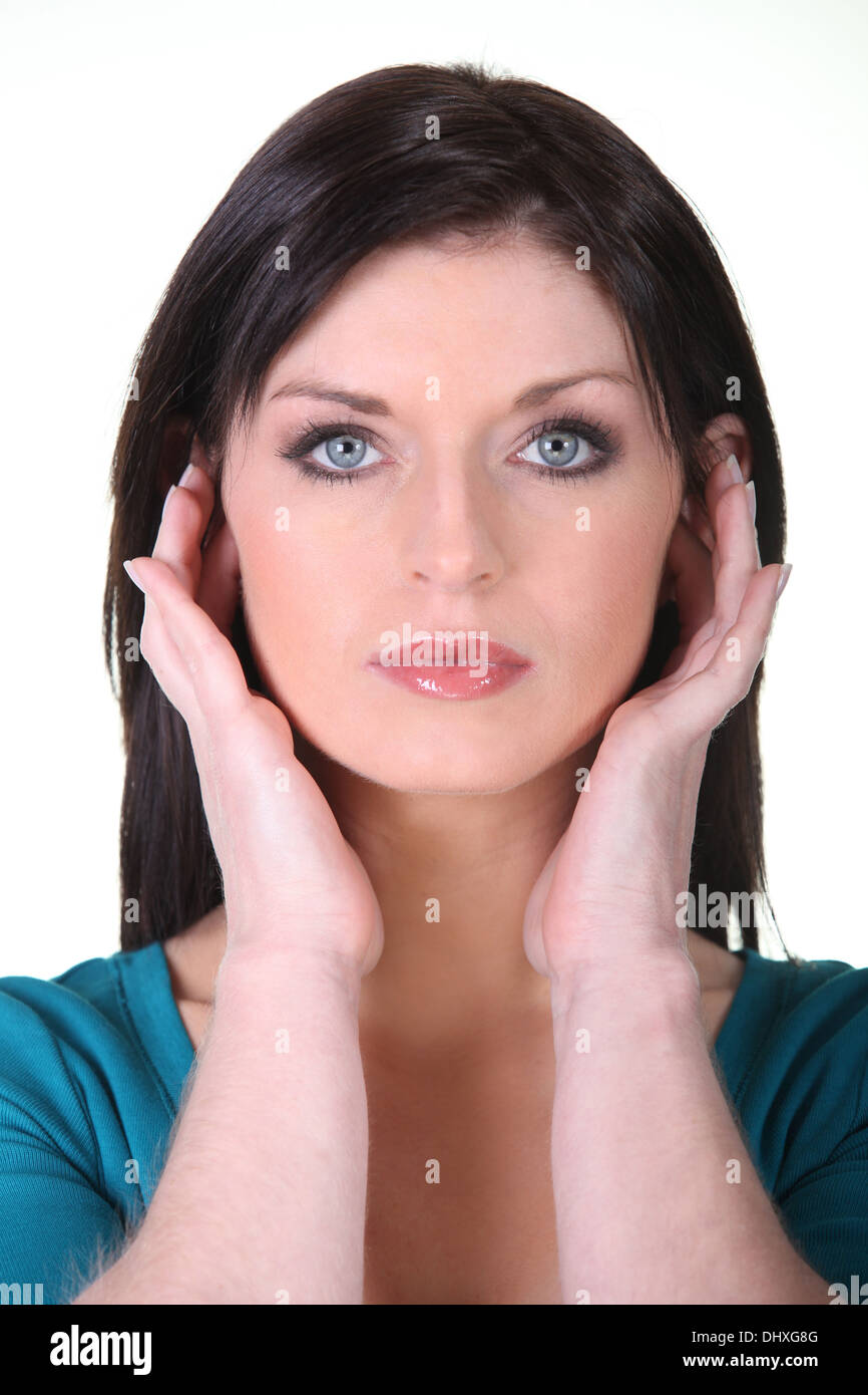 Woman covering her ears Stock Photo - Alamy
