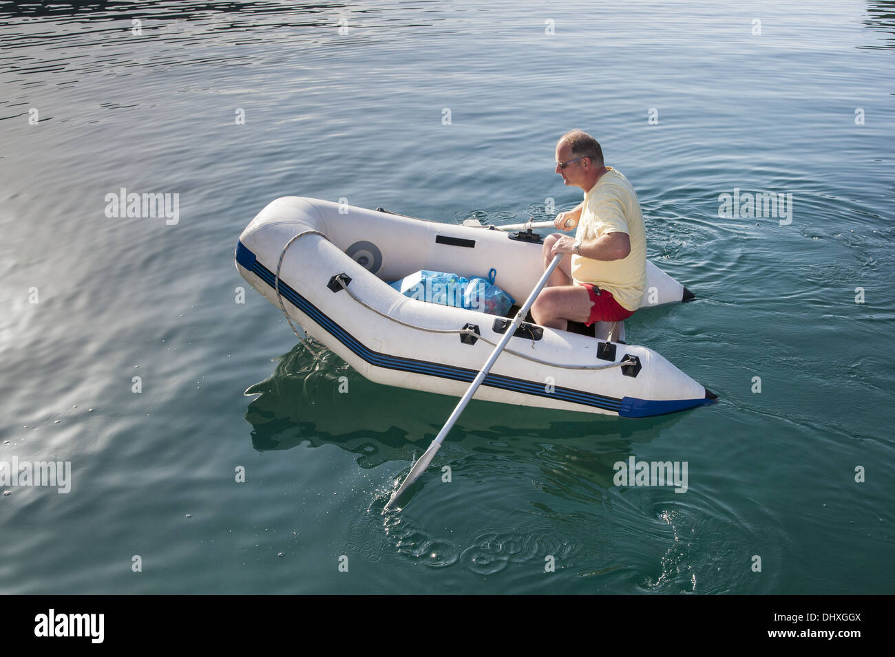 A white man rowing boat Stock Photo - Alamy
