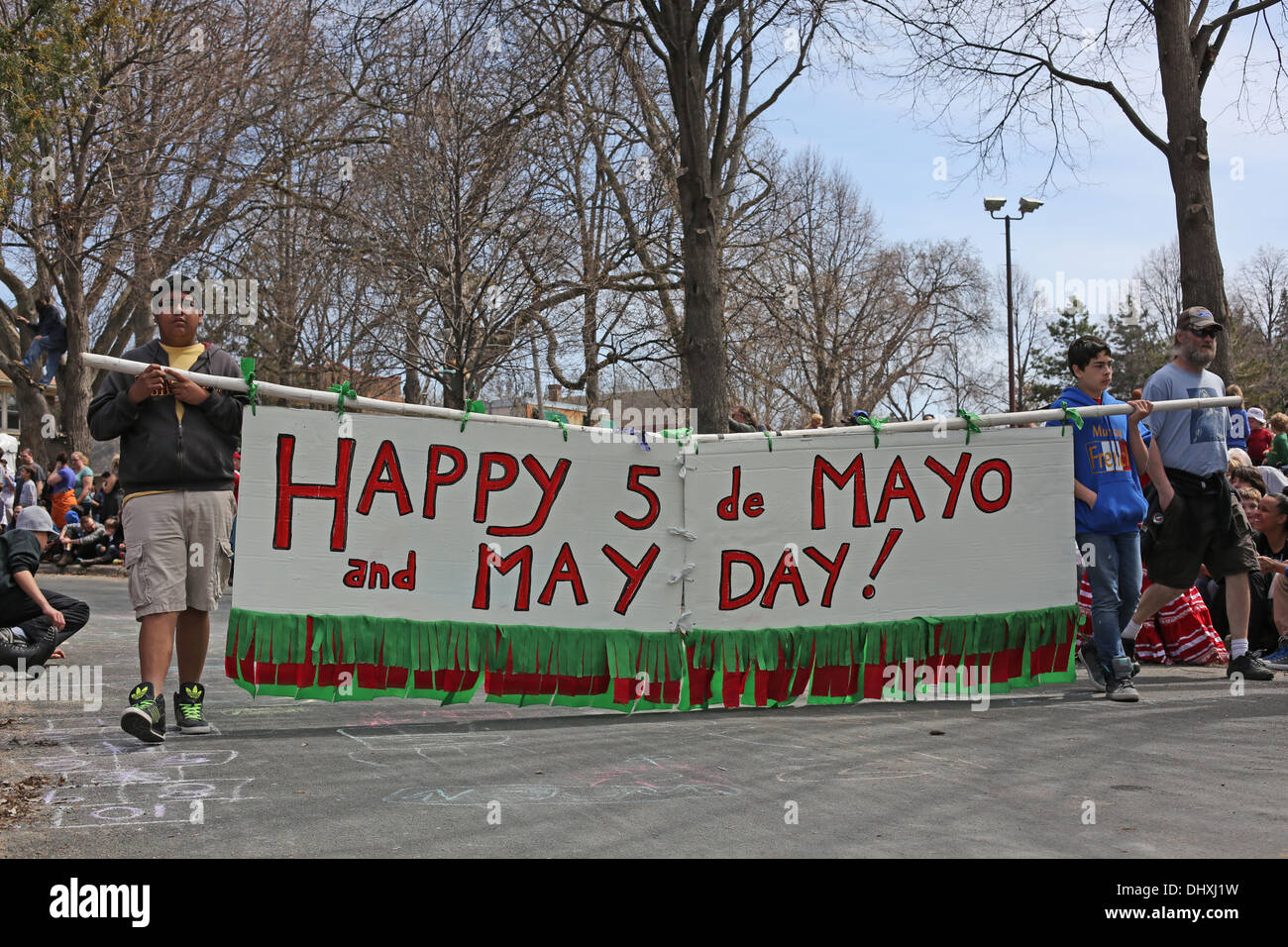 Marchers in the May Day parade in Minneapolis carrying a banner that reads happy May Day and ...