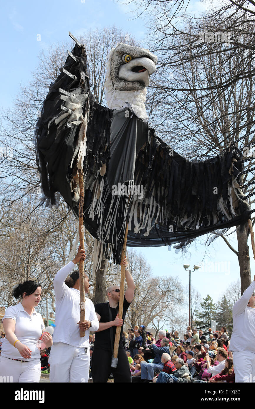 Marchers carrying a giant eagle puppet at the May Day parade and ...