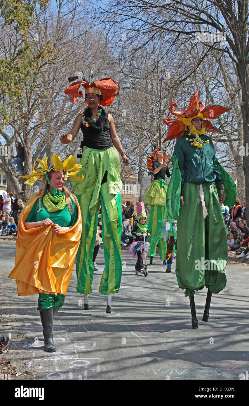 People on stilts and dressed as flowers at the May Day parade in ...