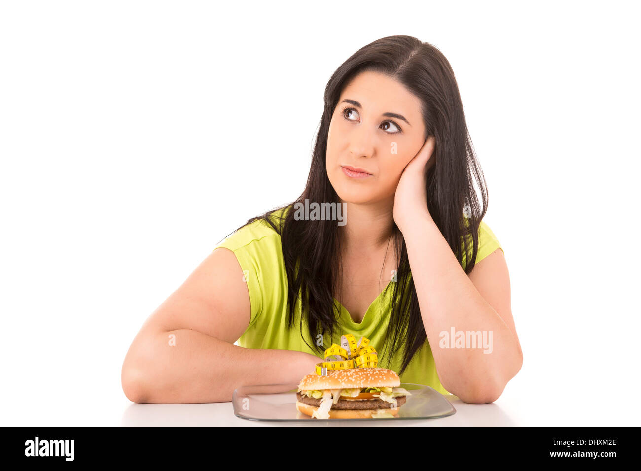 Beautiful large woman, trying to resist to an appetizing hamburger ...