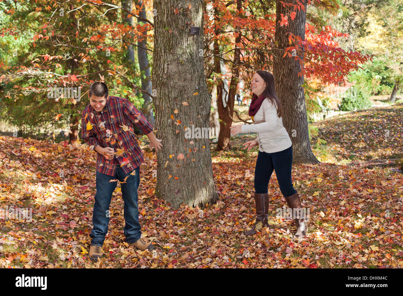 Loving couple posing together during the fall / autumn, with natural ...