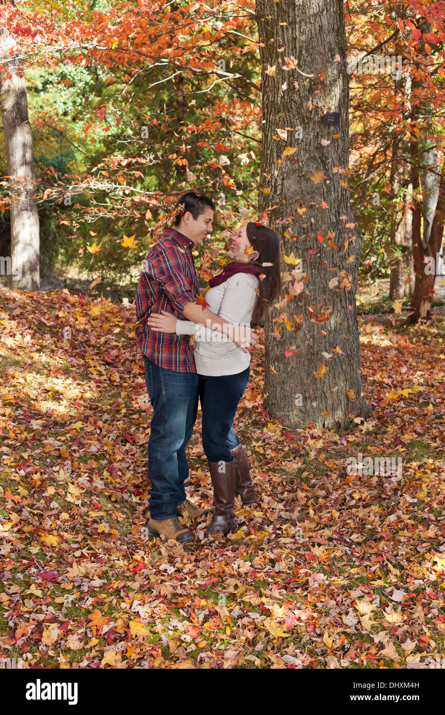 Loving couple posing together during the fall / autumn, with natural ...