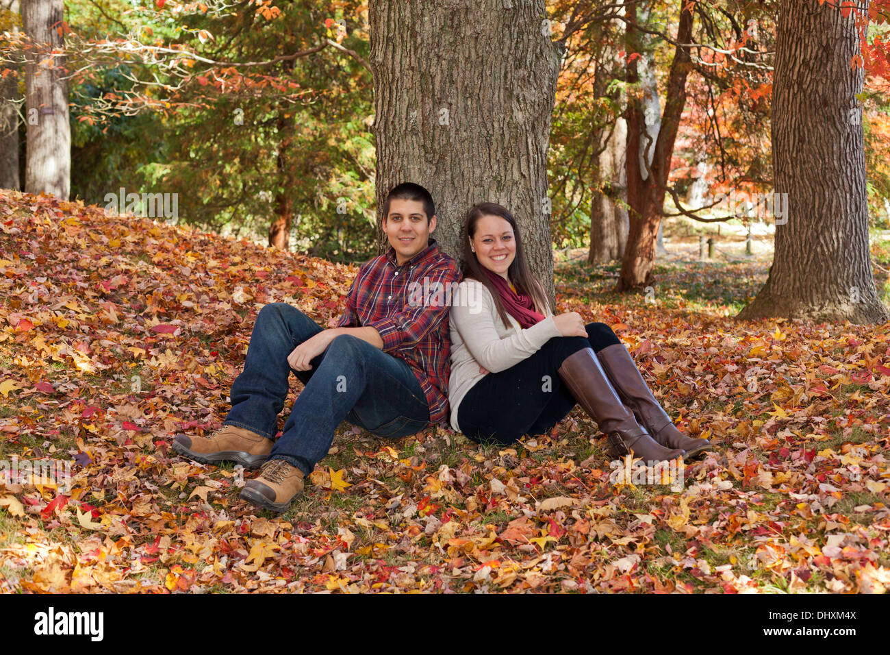 Loving couple posing together during the fall / autumn, with natural ...