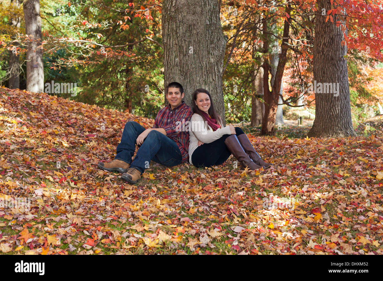 Loving couple posing together during the fall / autumn, with natural ...