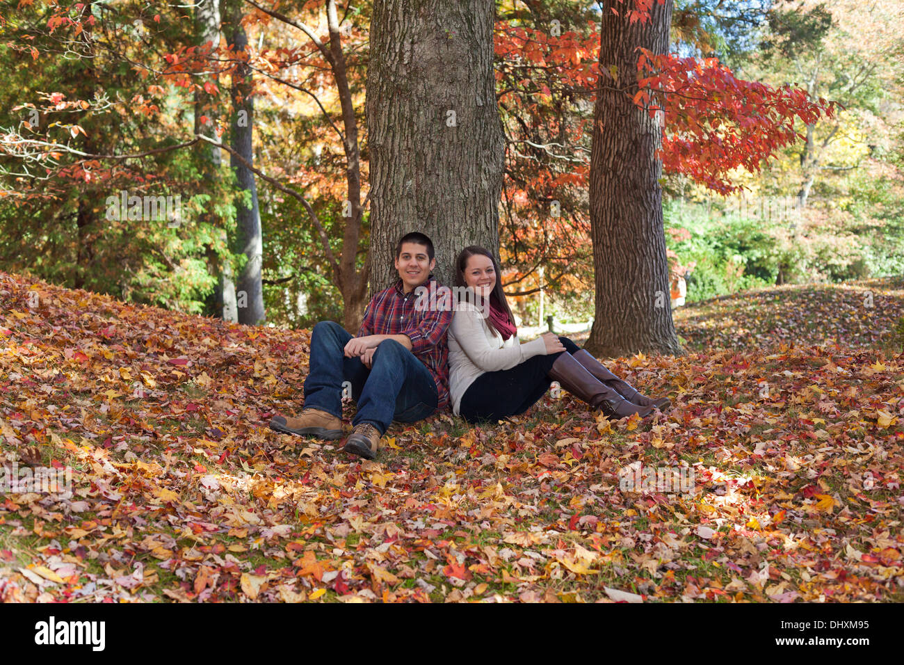 Loving couple posing together during the fall / autumn, with natural ...