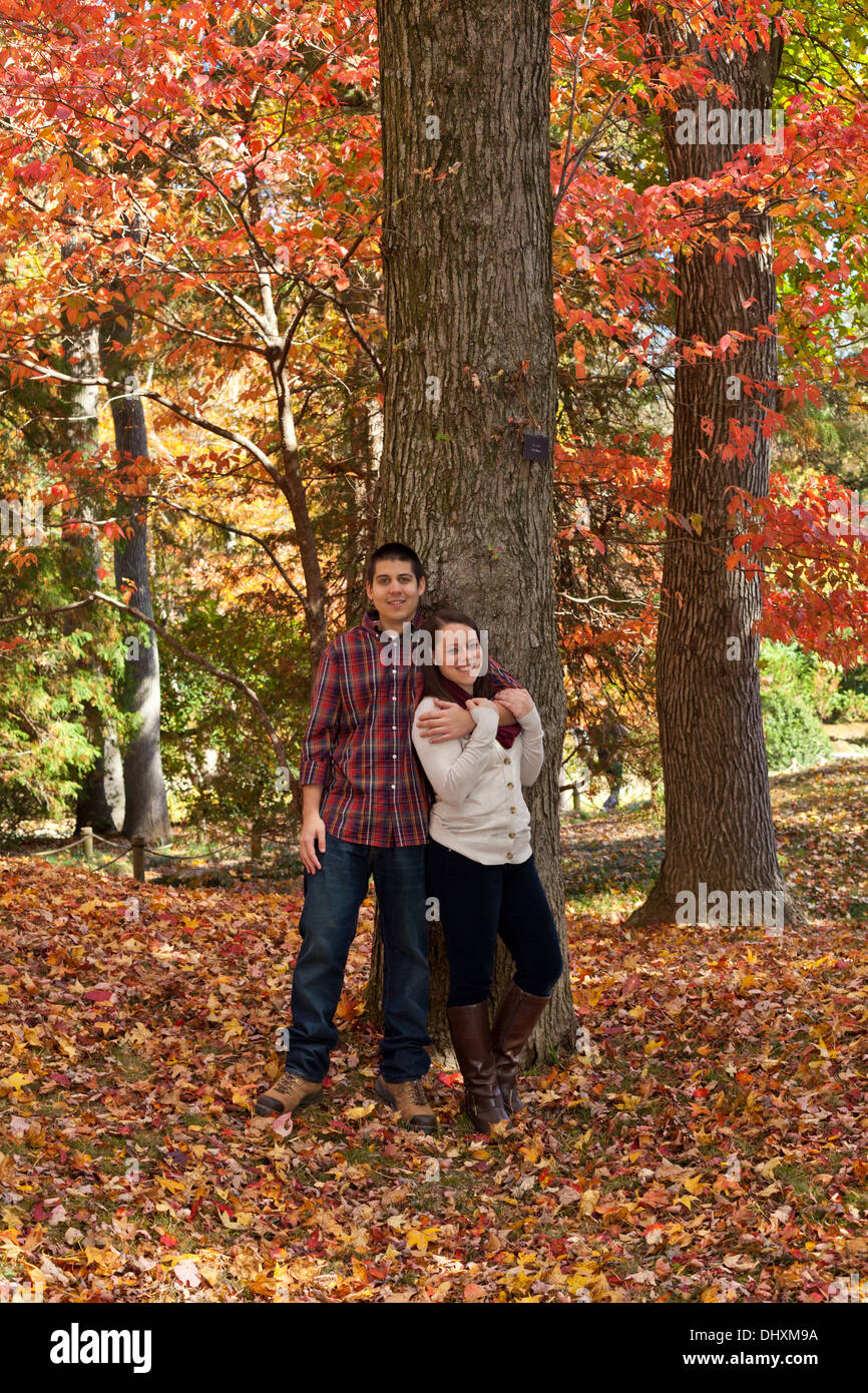 Loving couple posing together during the fall / autumn, with natural ...