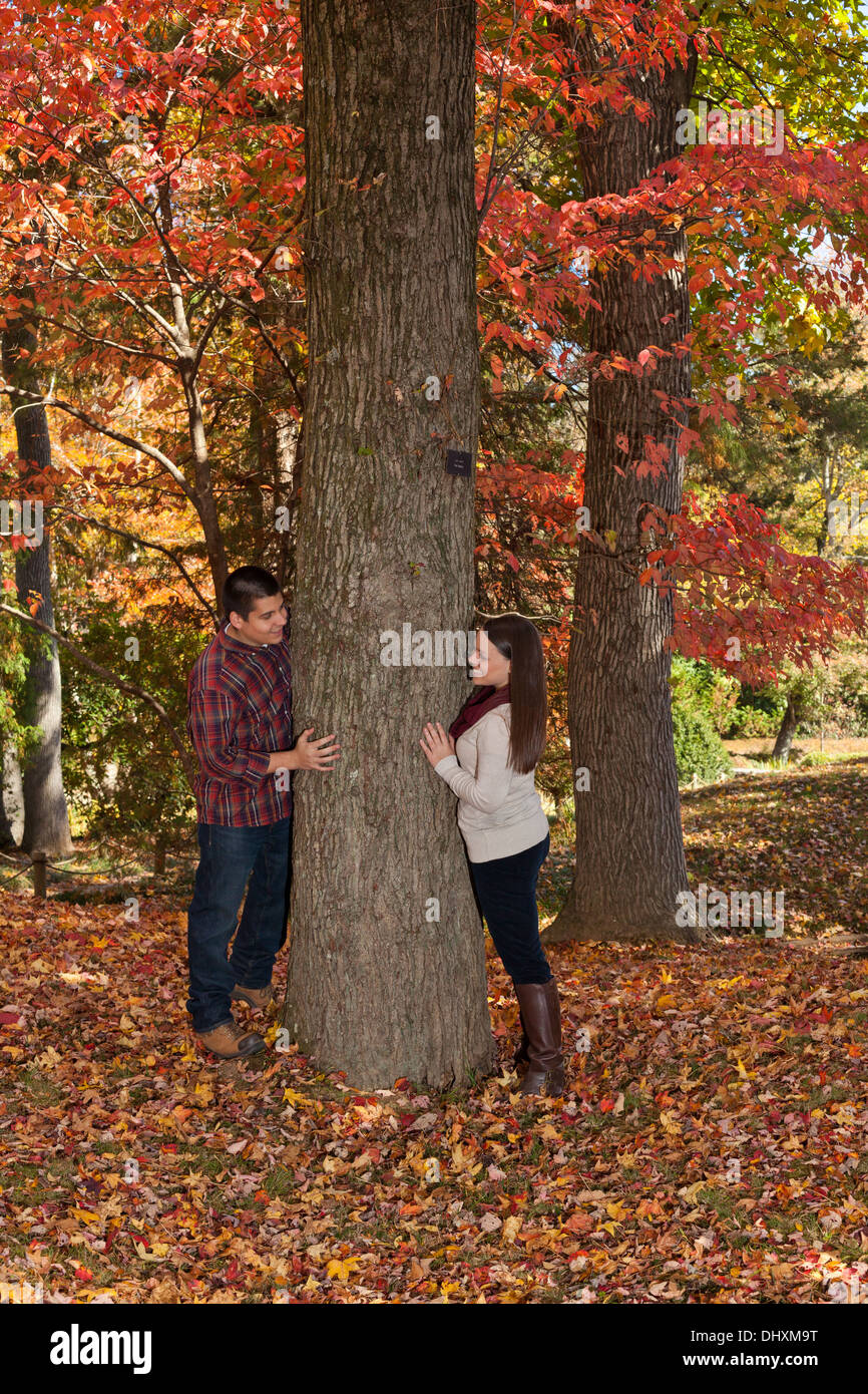 Loving couple posing together during the fall / autumn, with natural ...