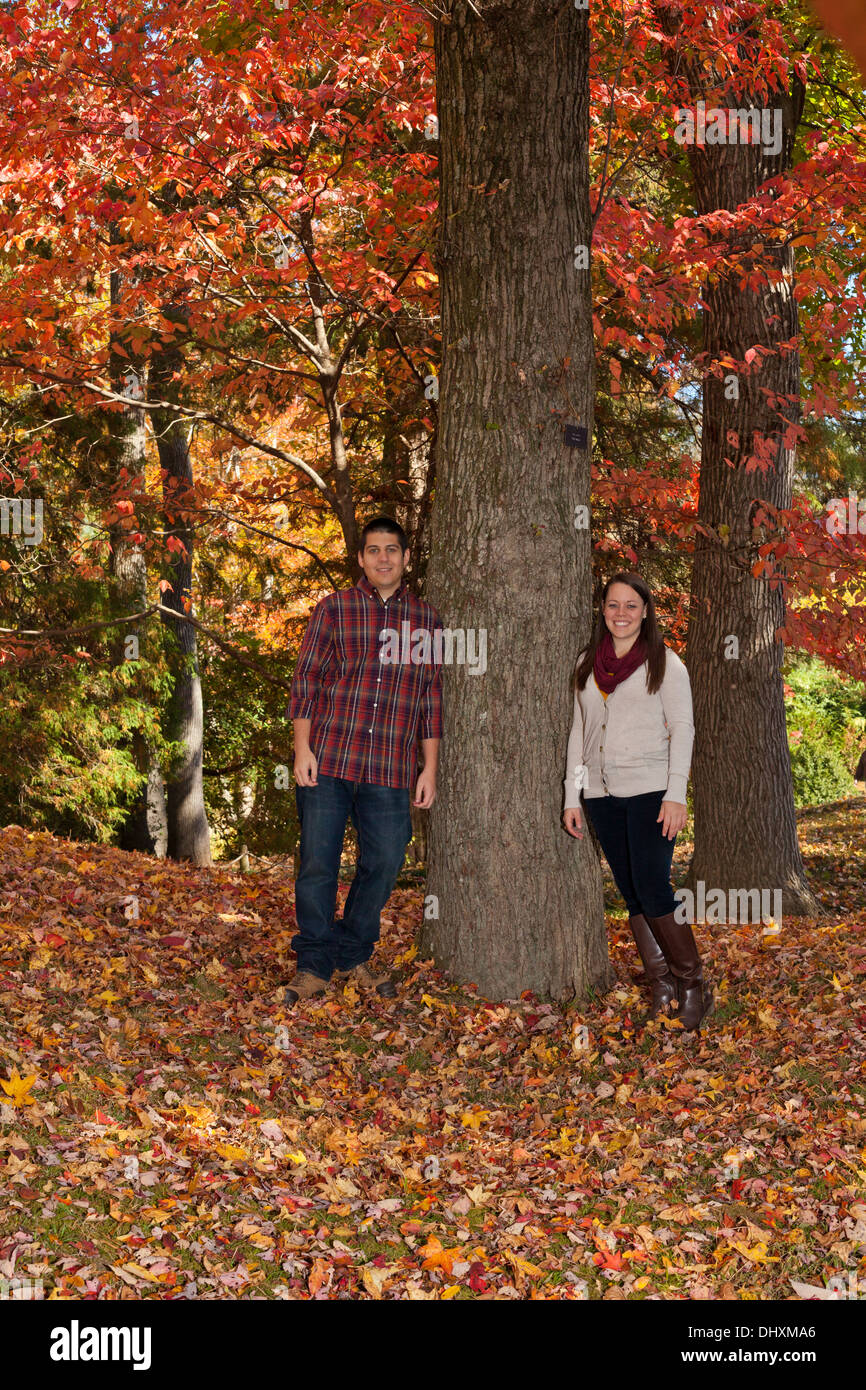 Loving couple posing together during the fall / autumn, with natural ...