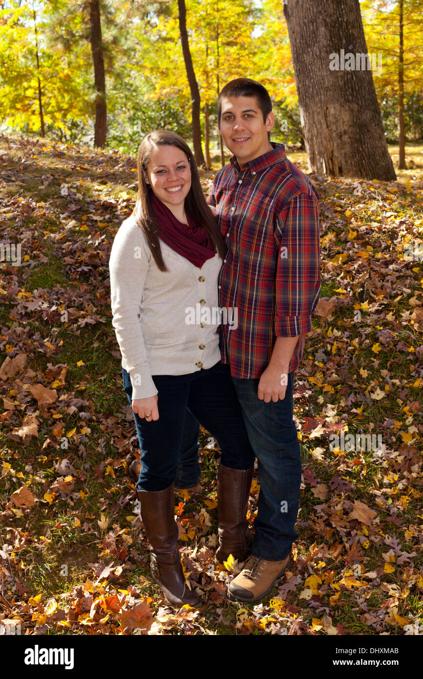 Loving couple posing together during the fall / autumn, with natural ...