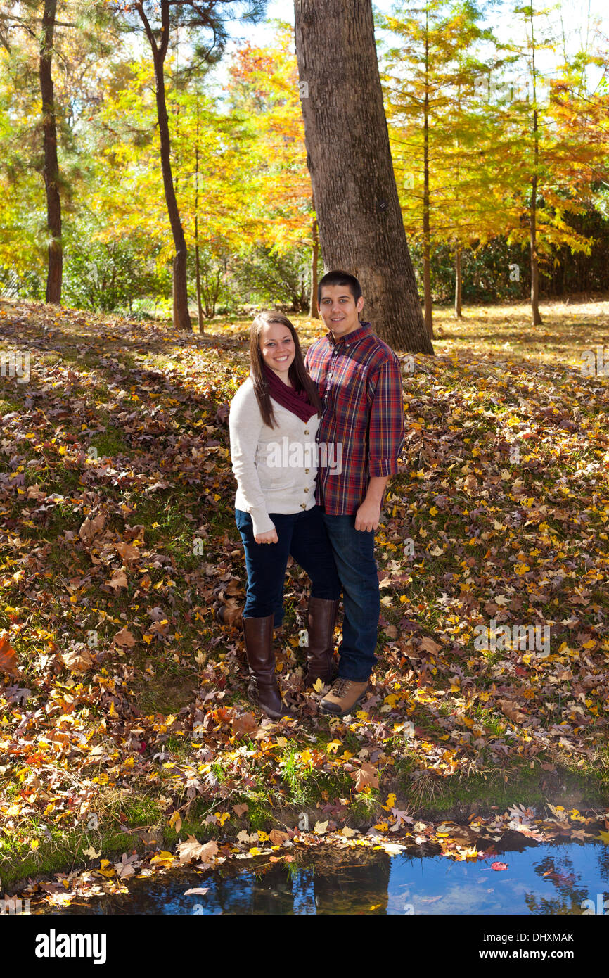 Loving couple posing together during the fall / autumn, with natural ...