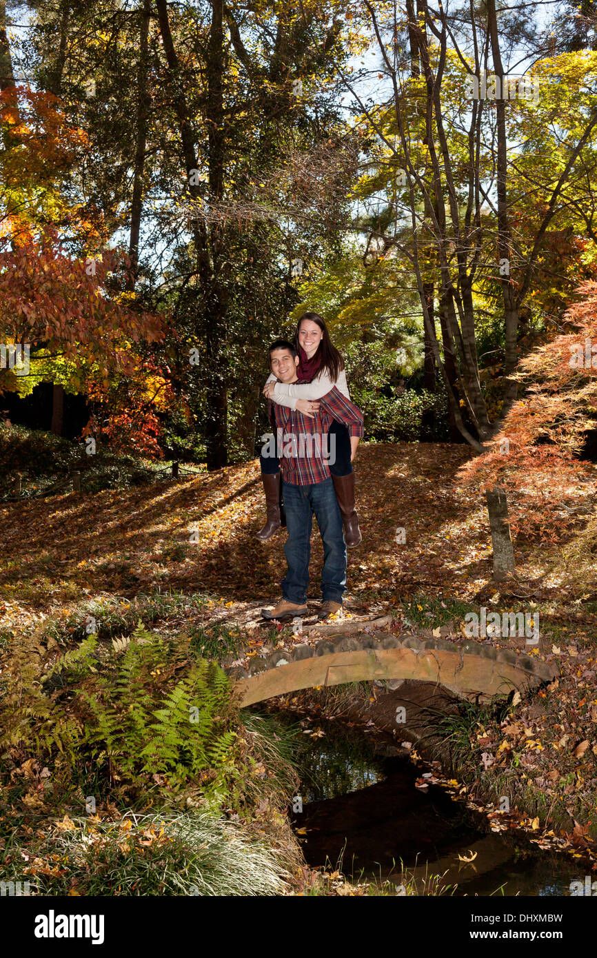 Loving couple posing together during the fall / autumn, with natural ...