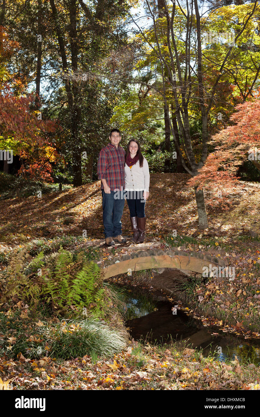 Loving couple posing together during the fall / autumn, with natural ...