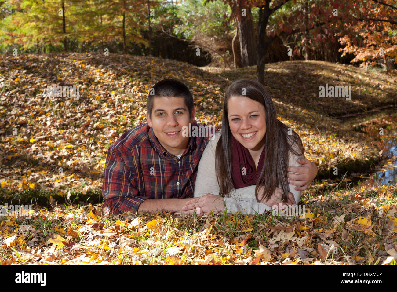 Loving couple posing together during the fall / autumn, with natural ...