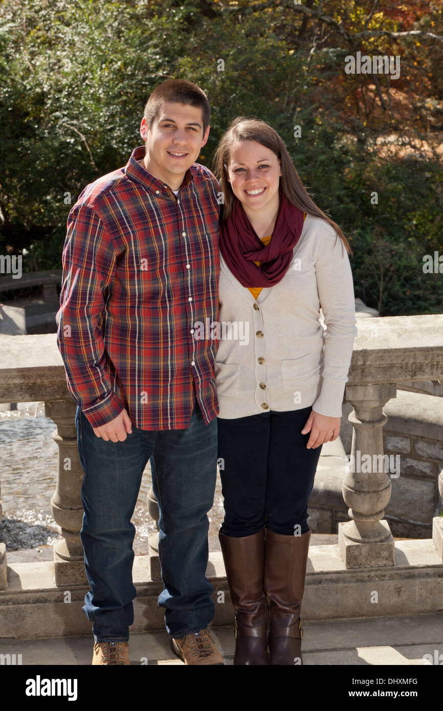 Loving couple posing together during the fall / autumn, with natural ...