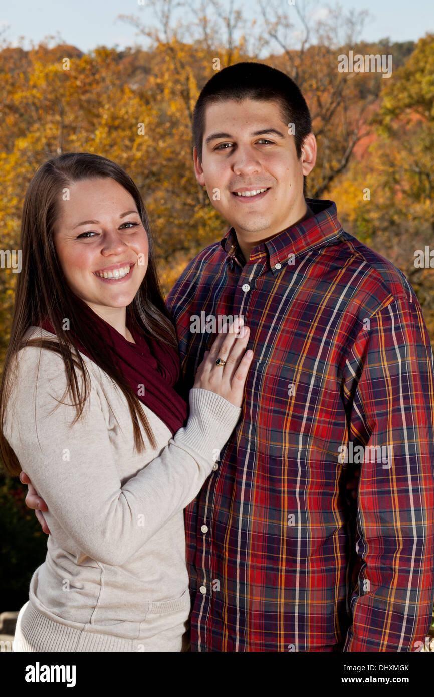Loving couple posing together during the fall / autumn, with natural ...