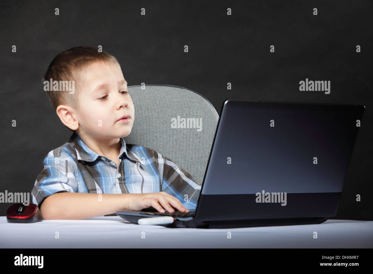 Computer addiction child boy with laptop notebook black background ...