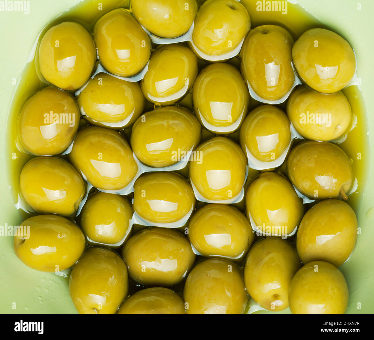 Green olives in olive oil Stock Photo - Alamy