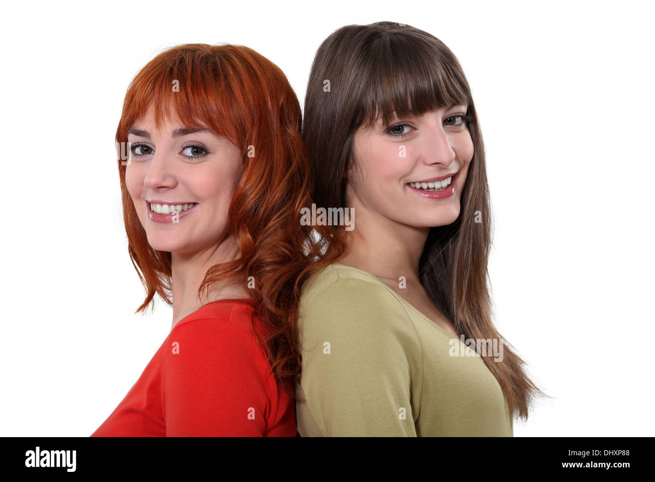 Friends standing back to back Stock Photo - Alamy