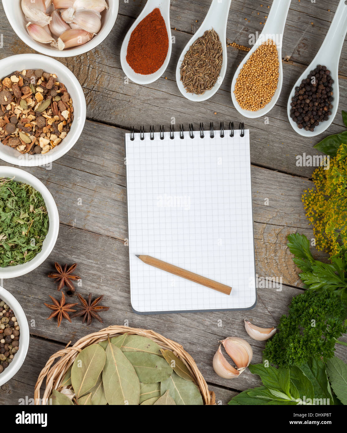Colorful herbs and spices selection. Aromatic ingredients on wood table ...